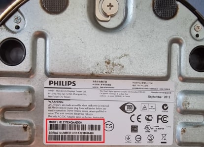 Where to find the model and serial number of a Philips monitor?